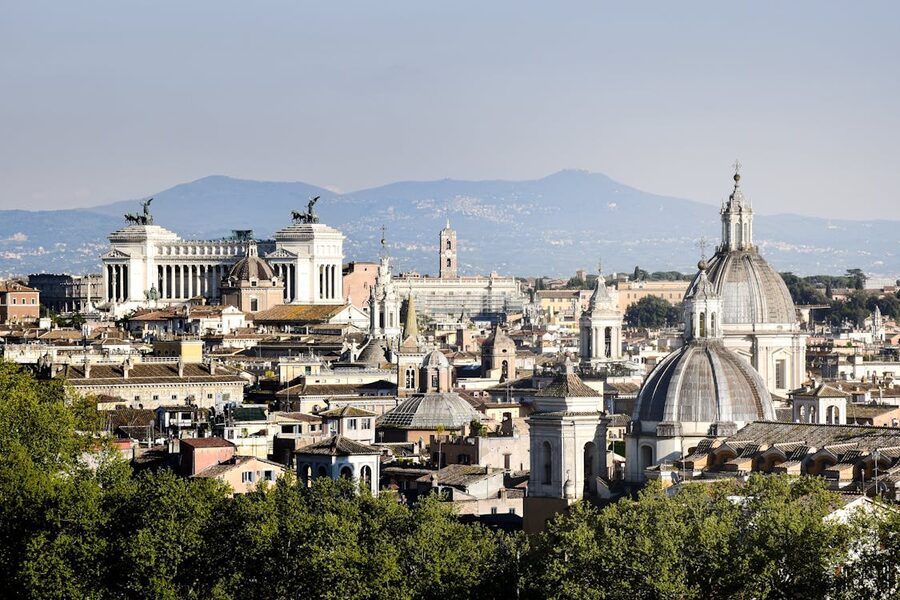 Beautiful panoramic view of Rome featuring multiple historic church domes and landmarks