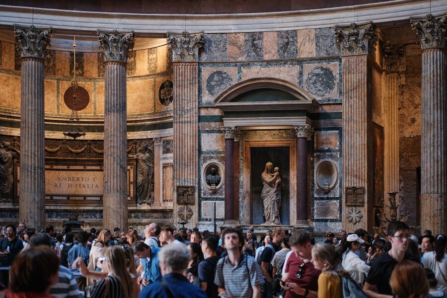 Crowds of visitors inside the Pantheon in Rome with majestic columns