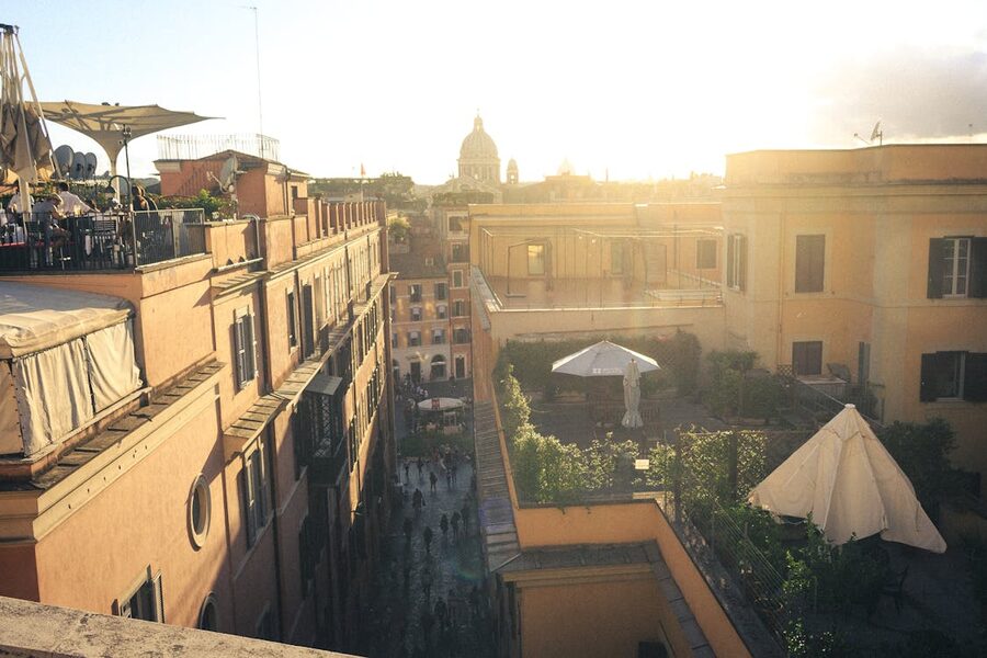 A sunset view over Rome historic rooftops from a rooftop restaurant terrace