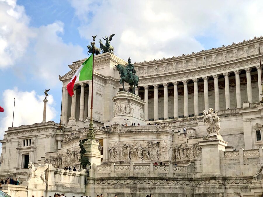 The Vittoriano Monument in Rome featuring grand architecture and Italian flags