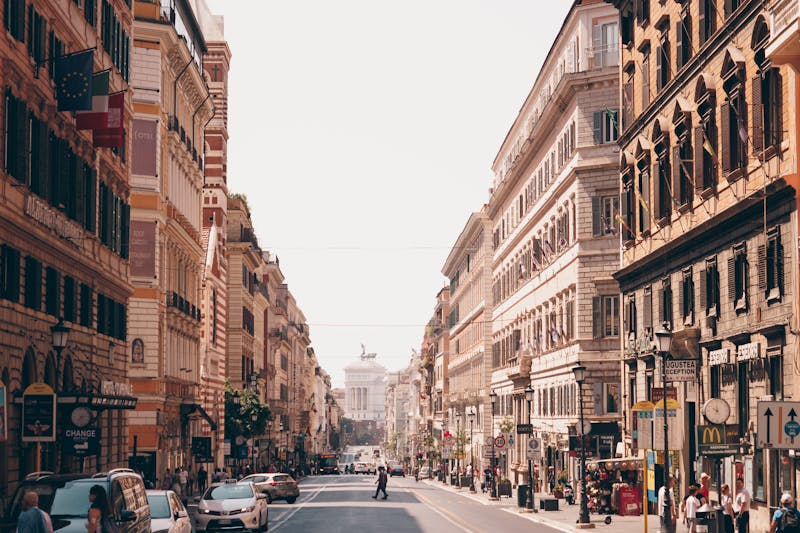 A busy urban street scene in Rome showcasing historic architecture