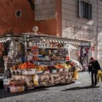 Colorful street market stall selling fruits and drinks in Rome city center