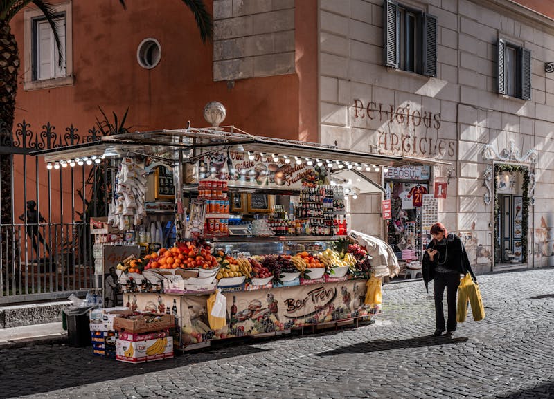 Colorful street market stall selling fruits and drinks in Rome city center