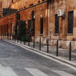 A quiet cobblestone street in Rome with classic architecture