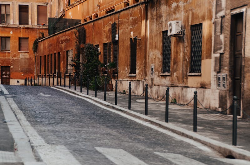 A quiet cobblestone street in Rome with classic architecture