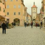 Picturesque street scene in Rothenburg ob der Tauber, showcasing medieval architecture and cobblestone streets.