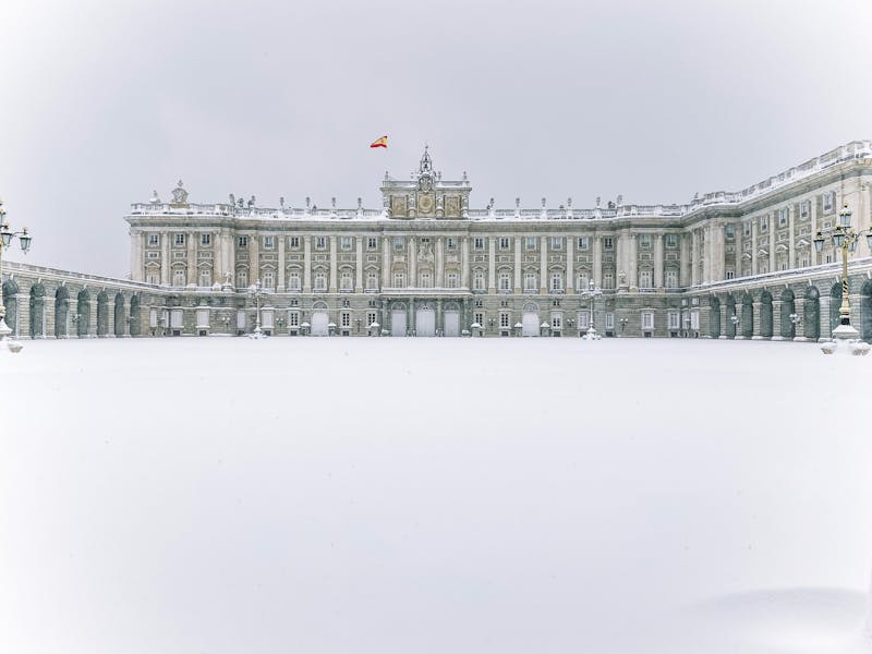 The Royal Palace of Madrid with snow-covered ground during winter