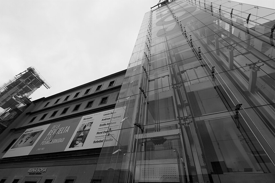 Reina Sofia Museum in Madrid showing the iconic glass elevator towers against a blue sky
