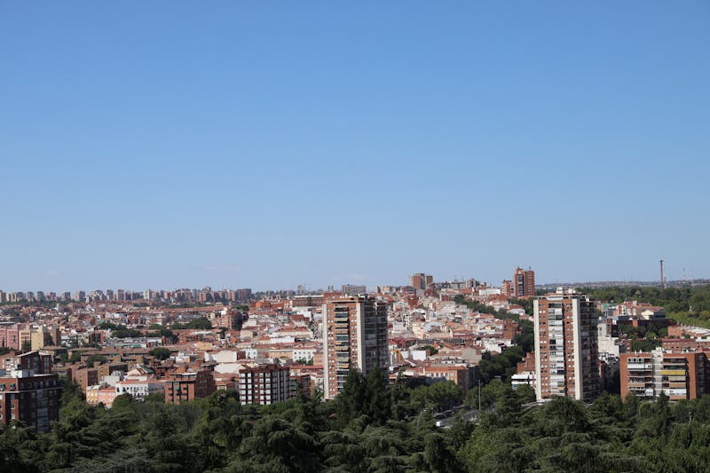 Expansive aerial view of Madrid showing urban landscape with clear blue sky