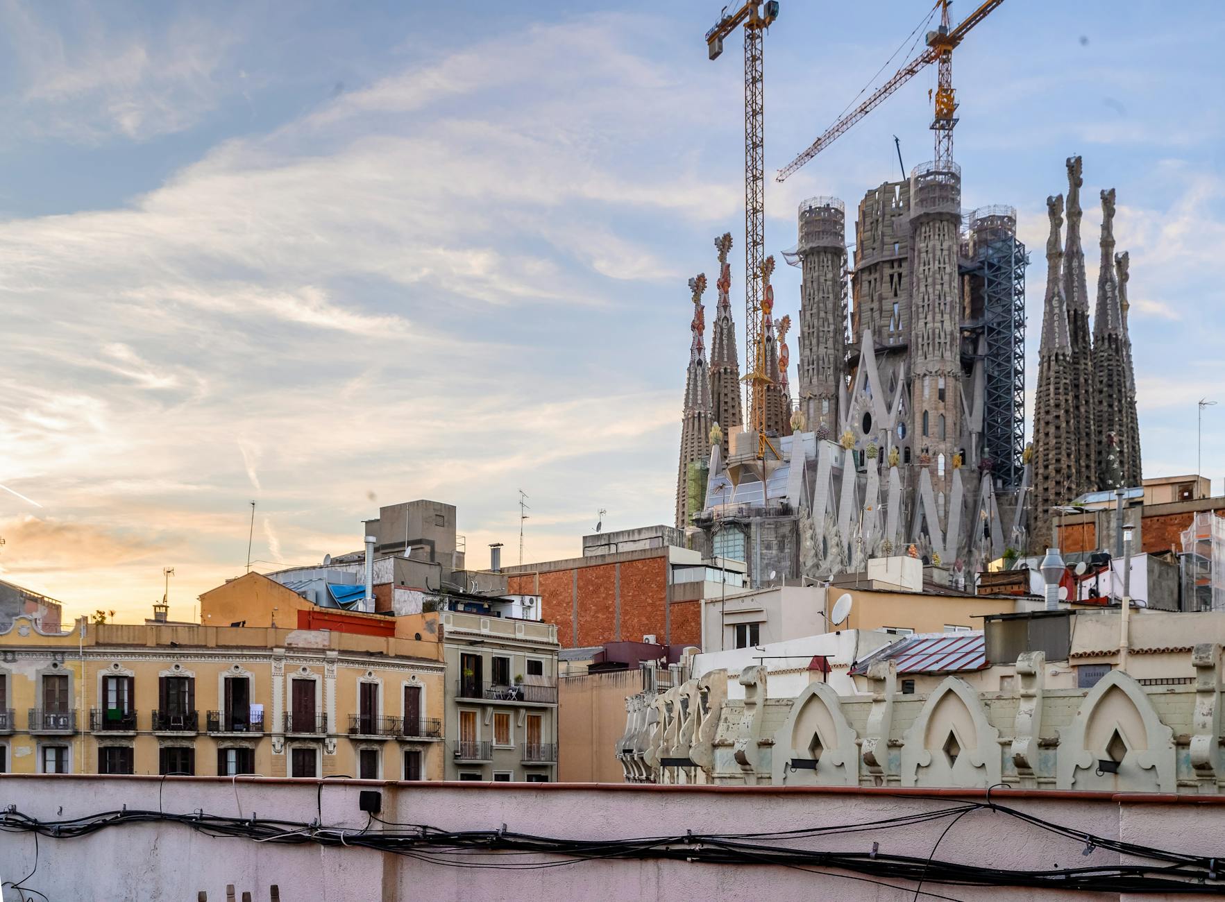 Sagrada Familia towers in Barcelona skyline at sunset
