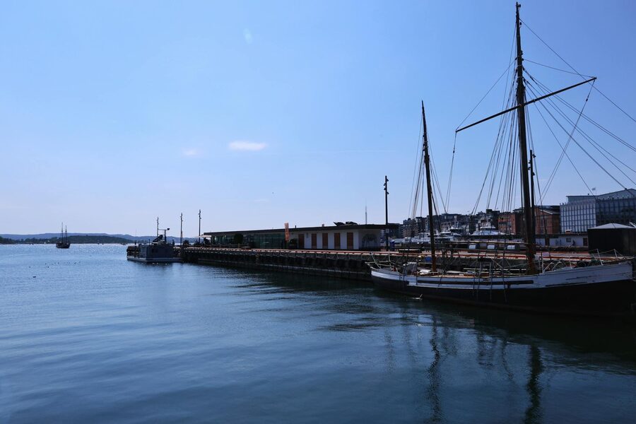 Aerial view of Bergen Norway with colorful buildings and harbor surrounded by fjords