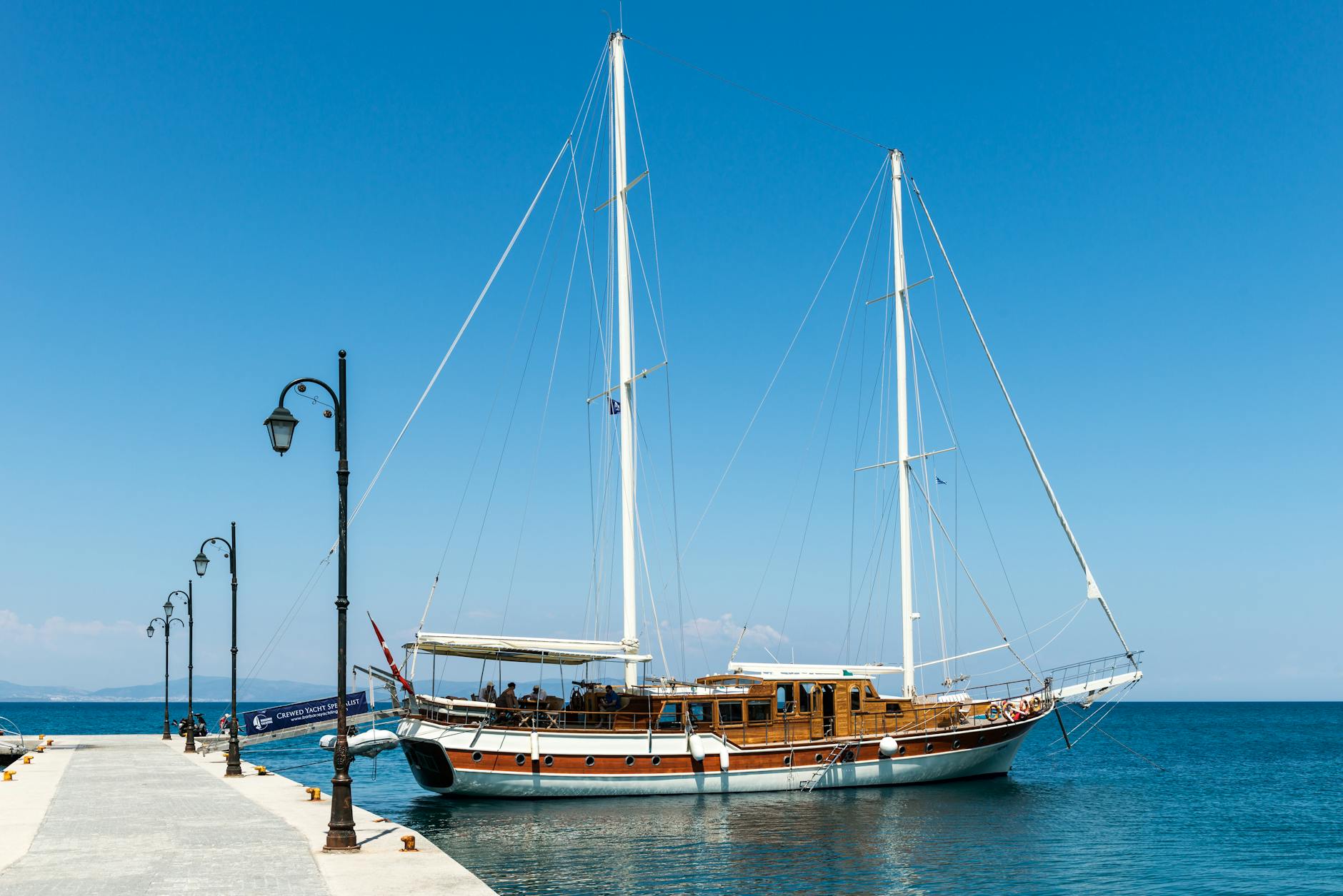 A sailing yacht on calm Mediterranean waters during the evening