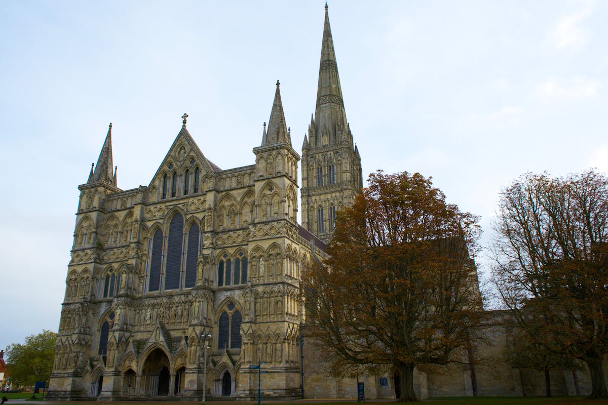 Gothic Salisbury Cathedral surrounded by colourful autumn foliage