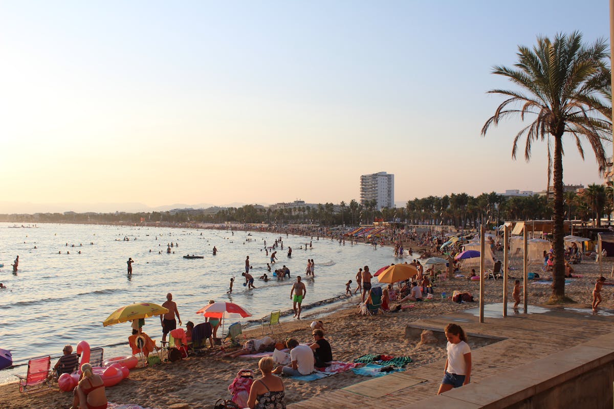 Crowded beach in Salou, Spain with people enjoying a sunny day