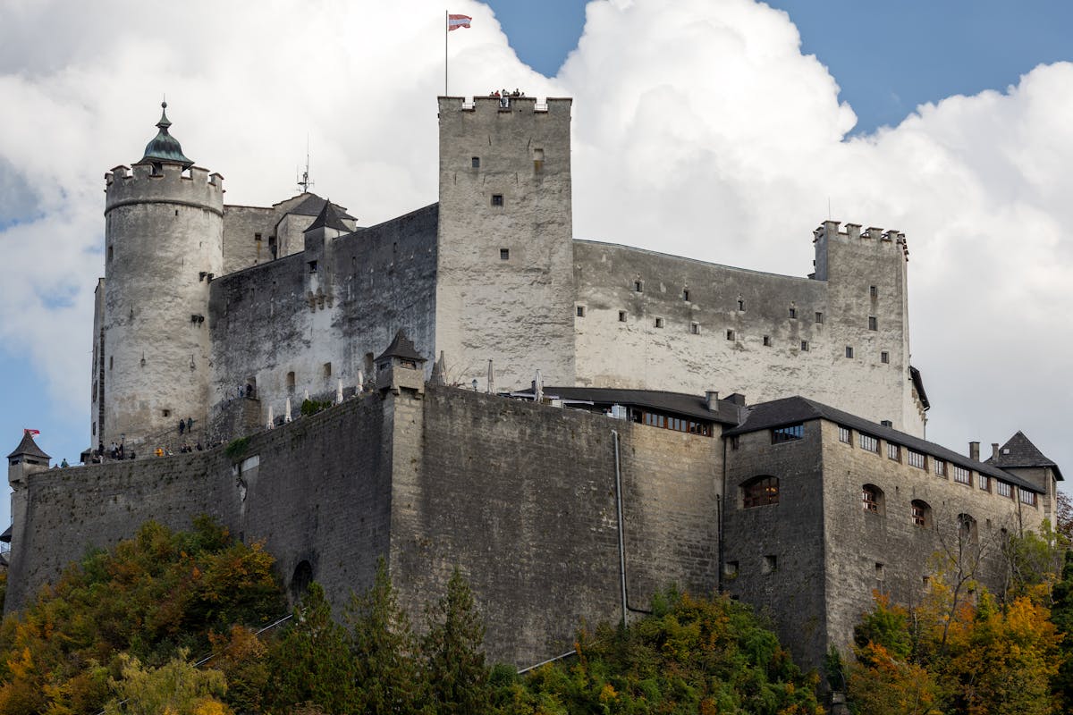 Hohensalzburg Castle surrounded by autumn foliage in Salzburg