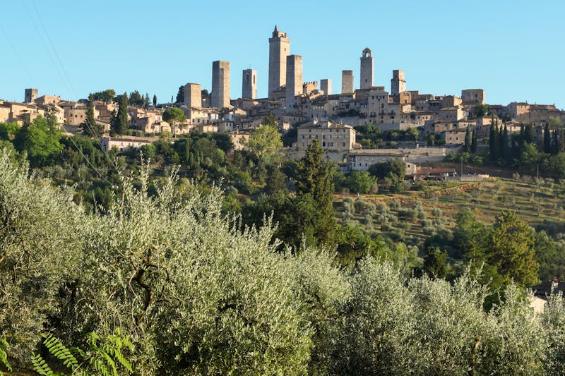 Dramatic skyline of San Gimignano with its iconic medieval towers against Tuscan landscape