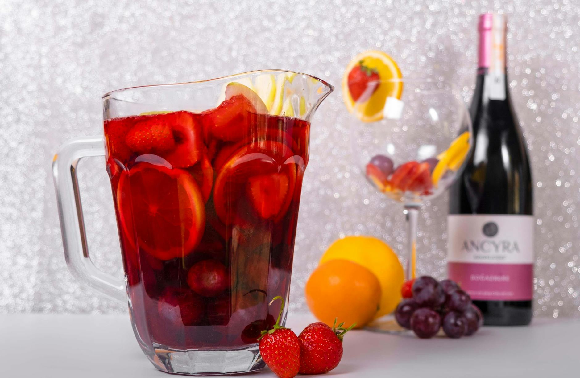 Pitcher of fruit sangria with fresh fruits, served outdoors in summer