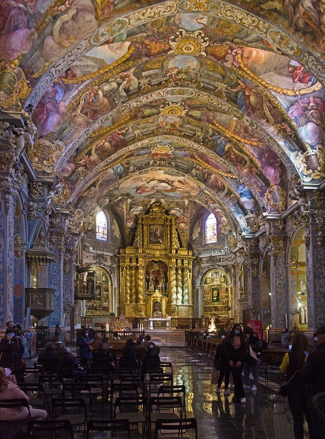 Interior view of the Church of Sant Nicolau in Valencia showing Baroque frescoes covering the ceiling and walls