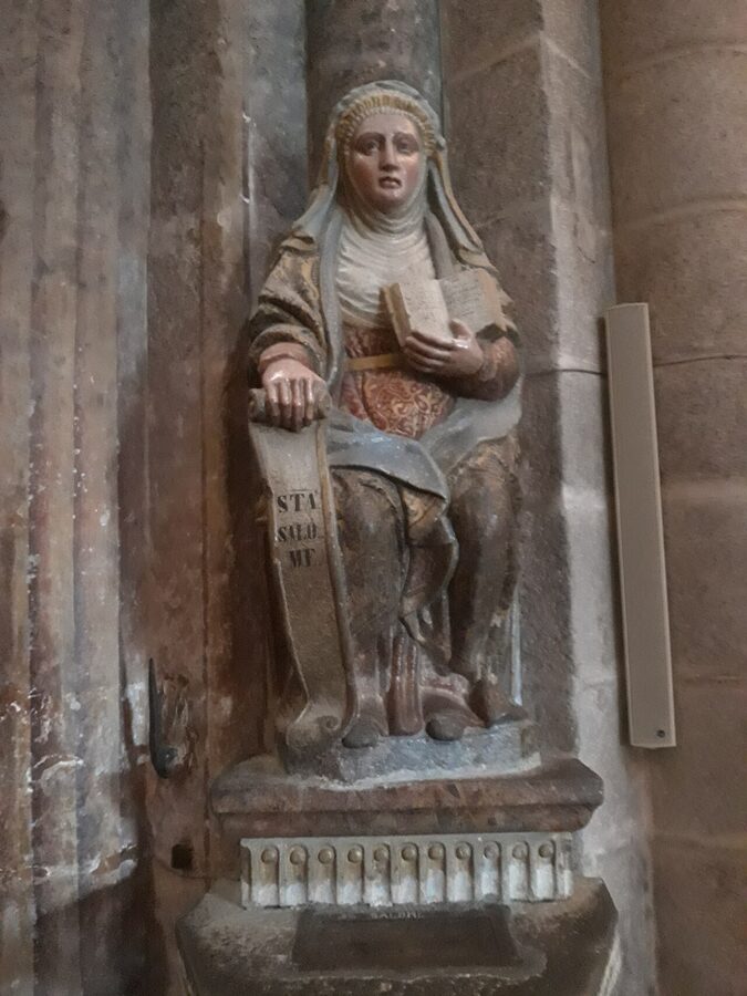 The grand interior nave of Santiago de Compostela Cathedral with ornate ceiling