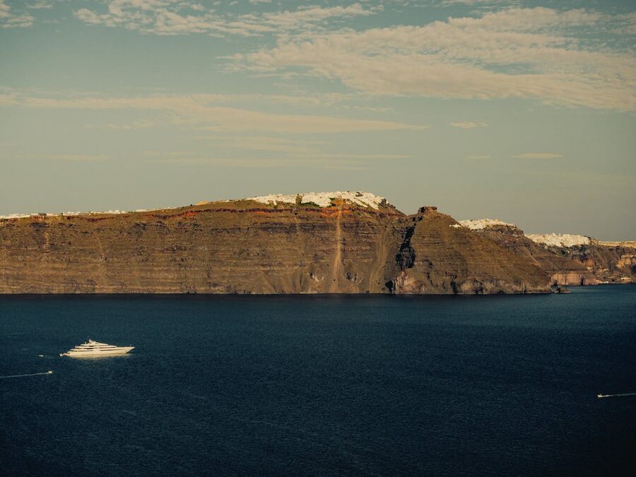 Santorini steep coastline with cruise ship in the Aegean Sea