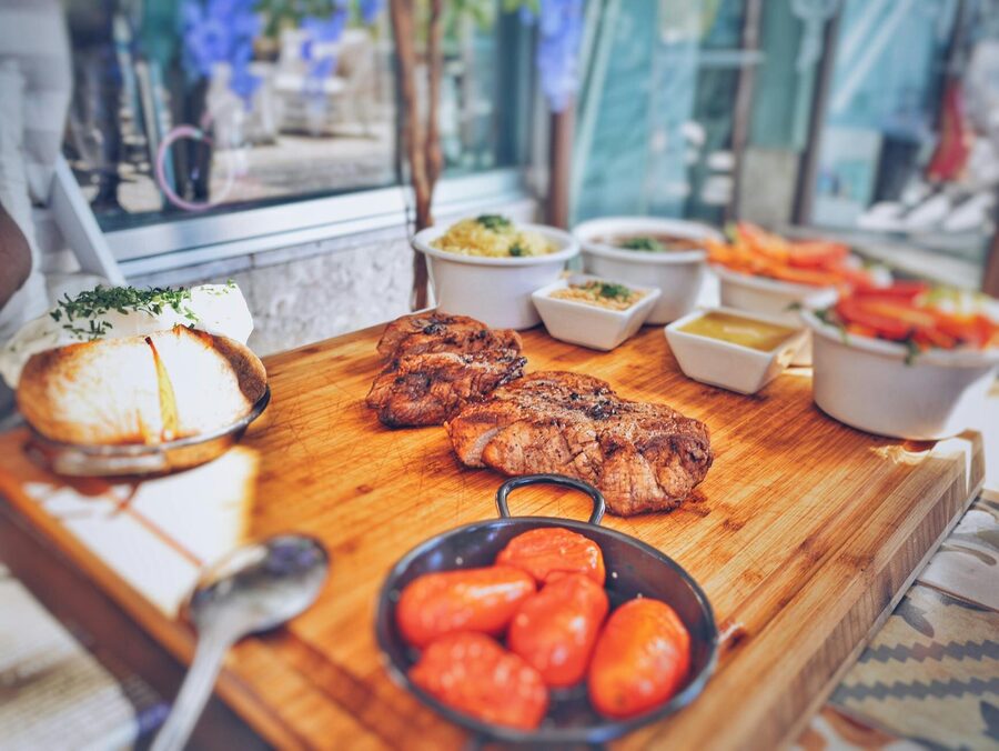 Portuguese cuisine with juicy grilled beef and fresh vegetables in a rustic setting