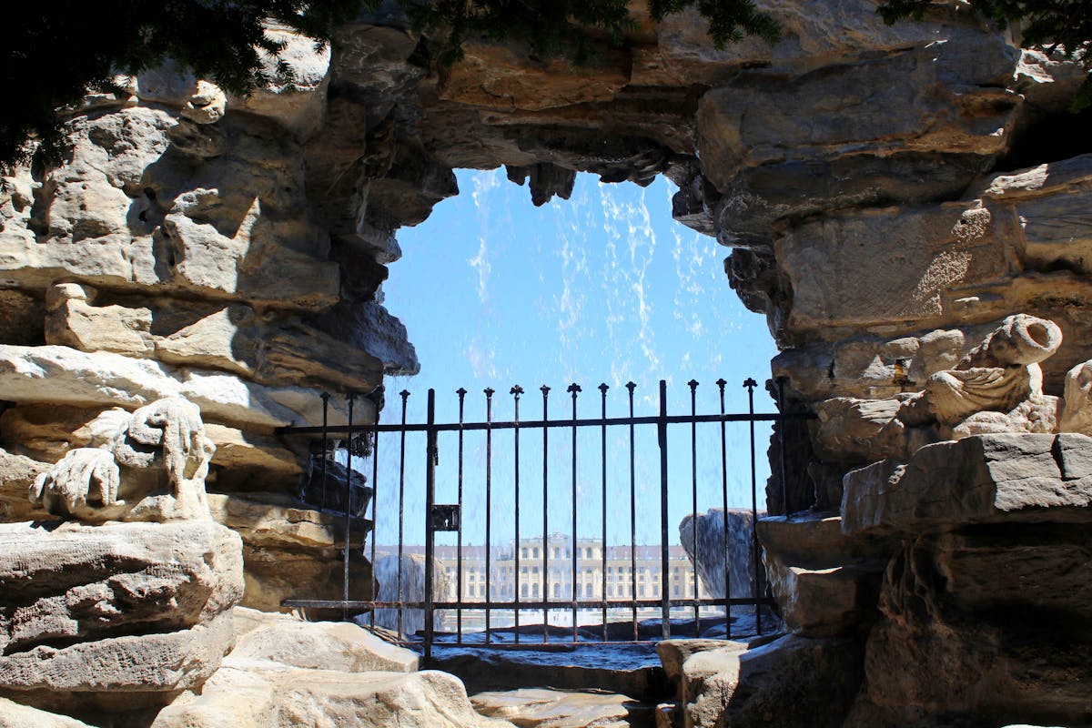 View through a rock arch of the Neptune Fountain at Schonbrunn Palace