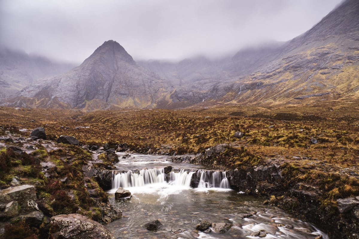 Waterfall cascading through the misty Scottish Highlands