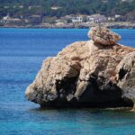 Rocky coastline with clear blue Mediterranean waters at Cala Ratjada in Mallorca Spain