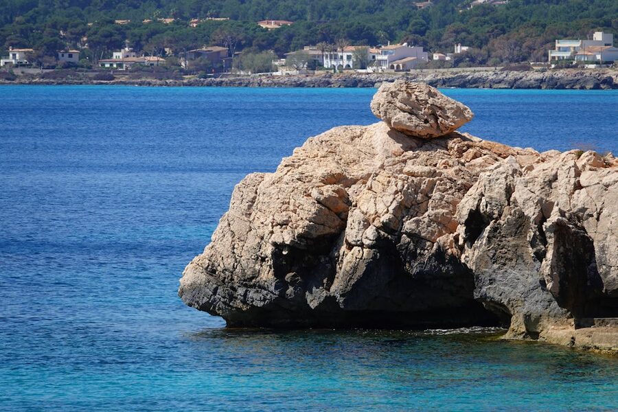 Rocky coastline with clear blue Mediterranean waters at Cala Ratjada in Mallorca Spain