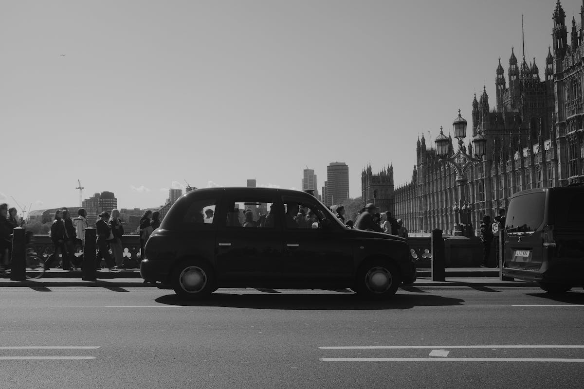 Black cab crossing Westminster Bridge with Houses of Parliament