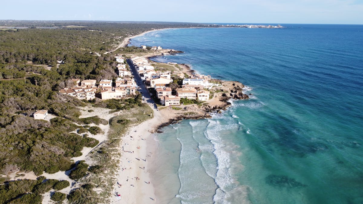 Aerial view of sandy beach and turquoise waters along the Mallorca coastline