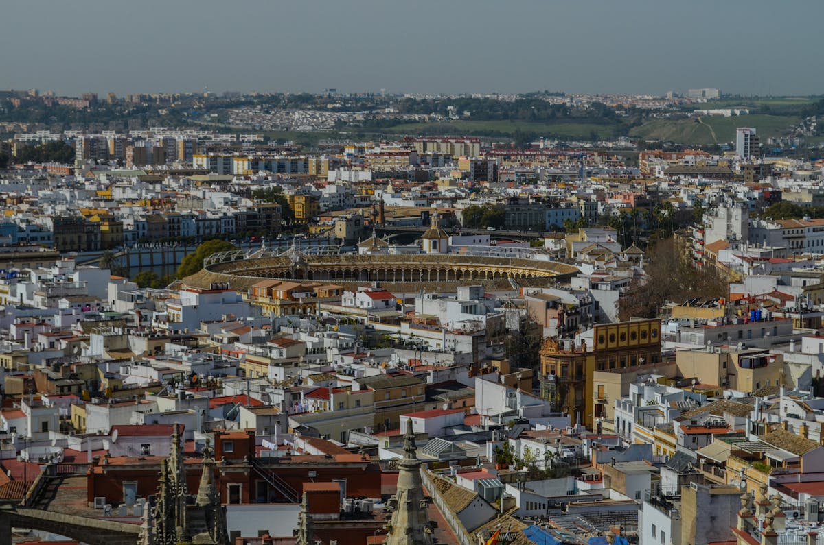 Aerial view of Seville showing the iconic bullring and surrounding cityscape