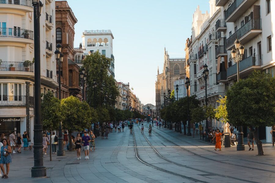Lively daytime street in Seville with architecture and pedestrians