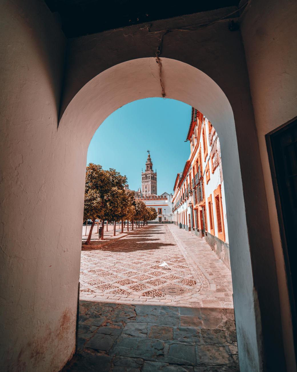 View of the Giralda Tower through an archway in Seville