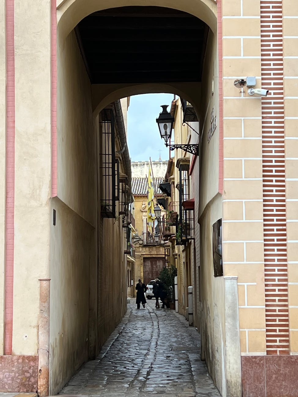 Cobblestone street with arches in Seville old town