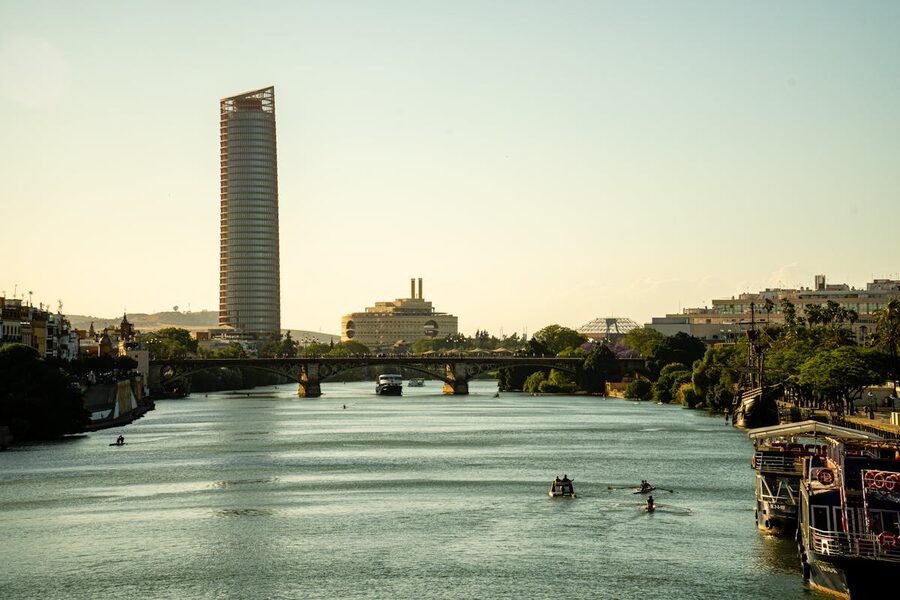 Tranquil view of Sevilles Guadalquivir river and city skyline at sunset