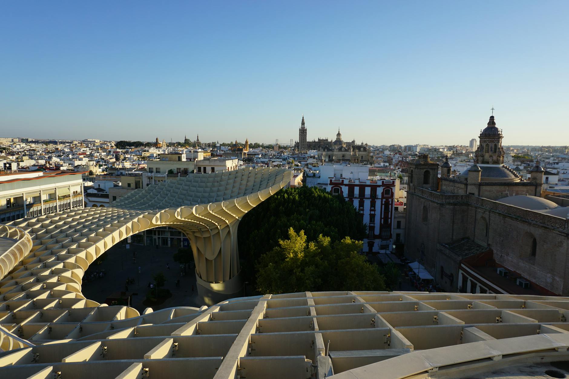 Panoramic view of Seville skyline at sunset with Metropol Parasol and historic landmarks
