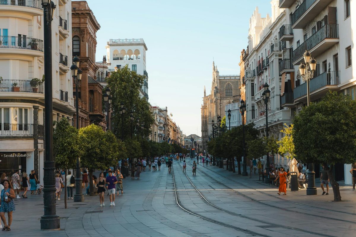 A sunny street scene in Seville with lively atmosphere