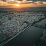 Aerial view of Seville showing the Guadalquivir River and cathedral at golden hour