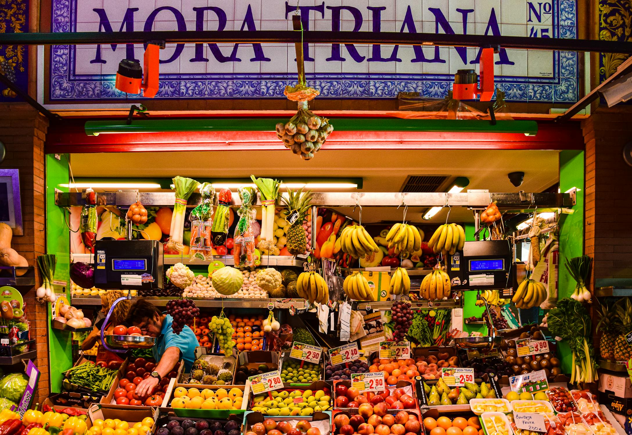 Colorful fruit stall inside the Triana Market in Seville