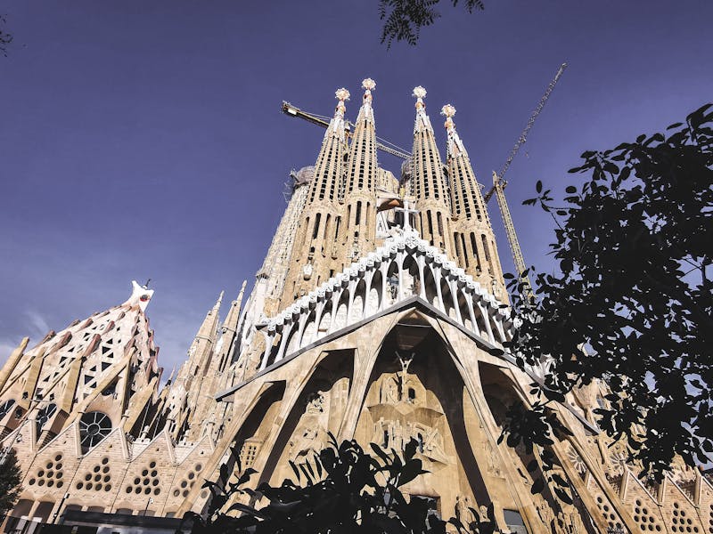 Looking up at the ornate spires and facade details of the Sagrada Familia