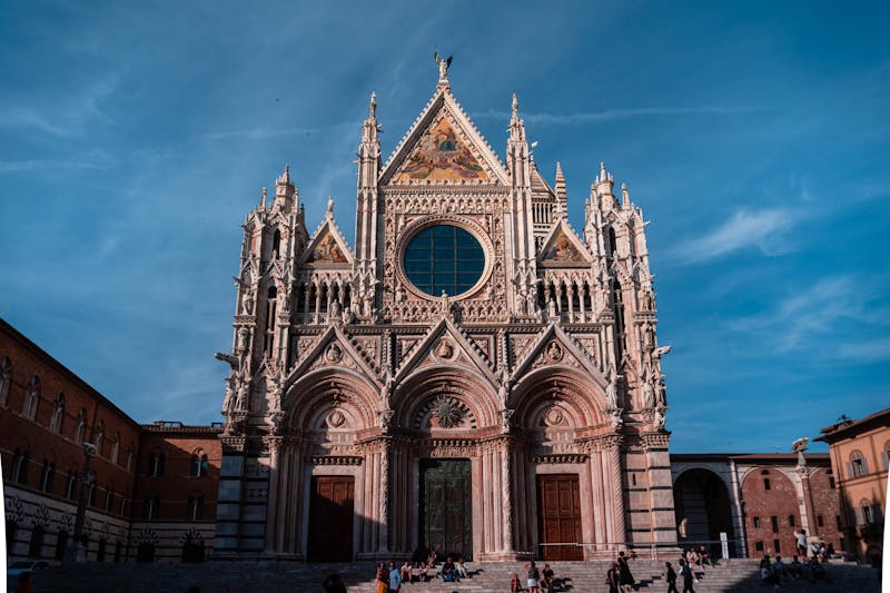 The Gothic facade of Siena Cathedral with its distinctive black and white marble stripes