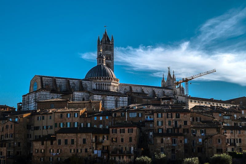 Panoramic view of Gothic Siena Cathedral under a clear blue sky in Tuscany Italy