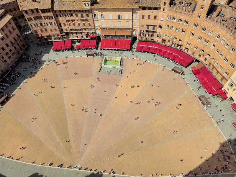 Fan-shaped Piazza del Campo in Siena seen from above with surrounding medieval buildings