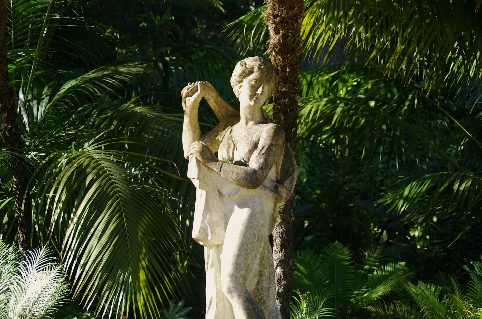 Marble statue in the gardens of Sintra surrounded by greenery