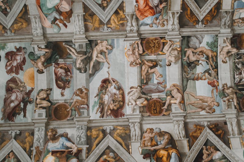 Intricate frescoes painted by Michelangelo covering the Sistine Chapel ceiling in Vatican City