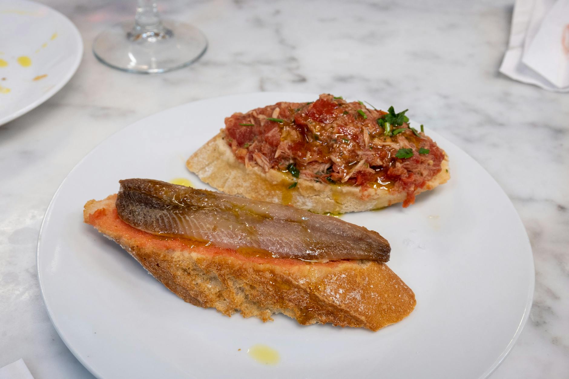 Outdoor restaurant terrace with tapas and wine overlooking the sea in Sitges