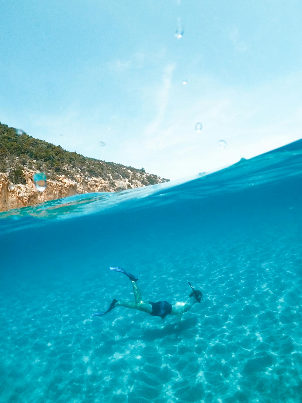 Man snorkeling in clear blue waters of the Mediterranean