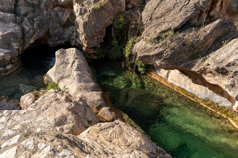 Natural rock pools with clear water surrounded by rocky landscape in Comunidad Valenciana, Spain