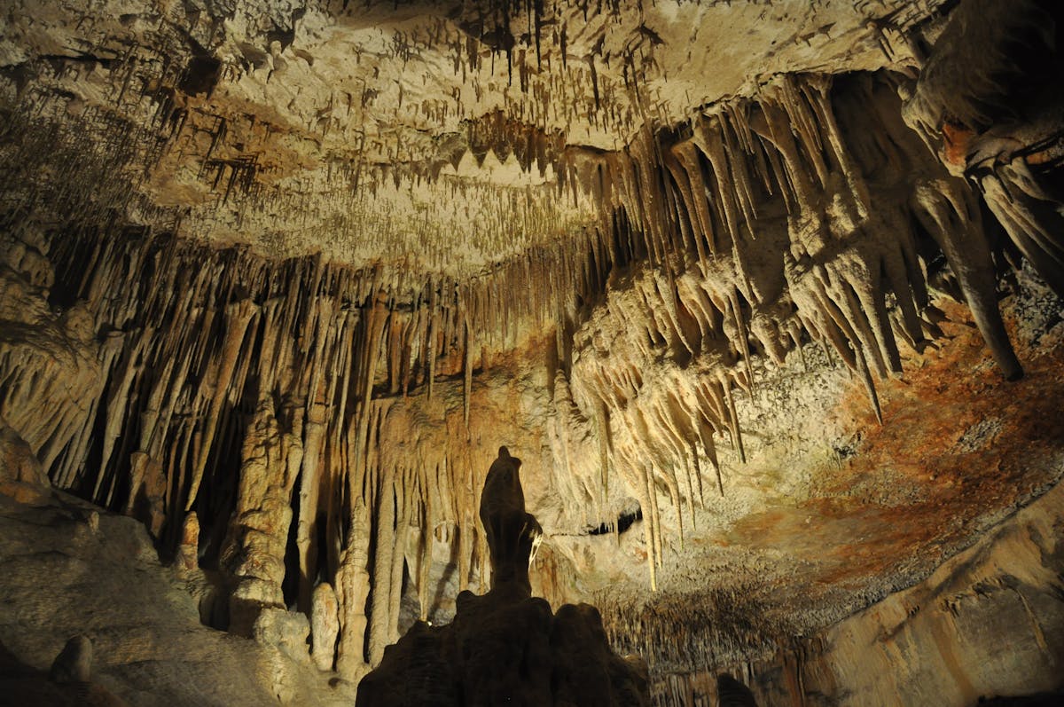 Impressive stalactite formations inside a cave in Spain with soft lighting